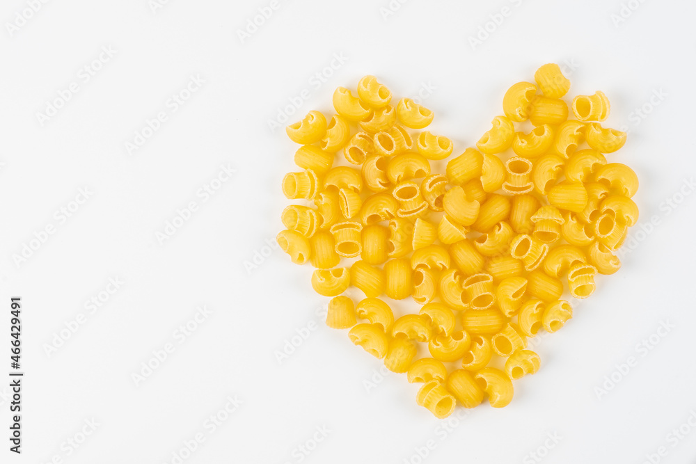 pasta is laid out in the shape of a heart. Food background and ...