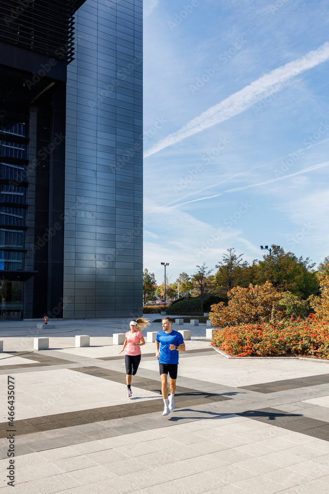 Male and female athletes running on footpath Stock Photo | Adobe Stock