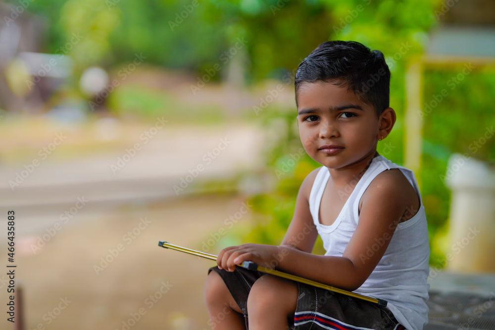Cute indian little boy studying at home Stock Photo | Adobe Stock