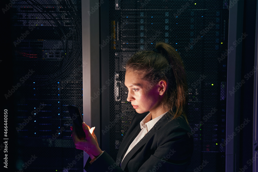 Woman engineer working in data center by server storage racks Stock ...