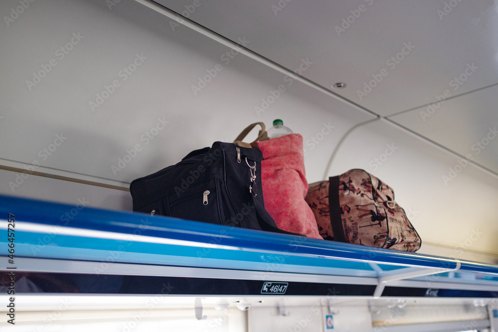 Lots of plastic suitcases and carry-on bags in the luggage compartment ...
