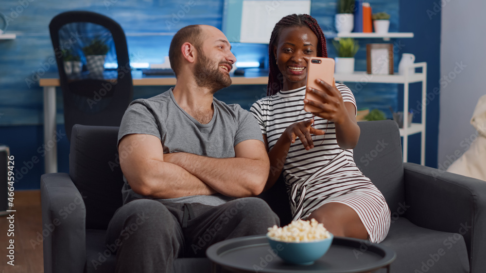 Modern interracial couple talking on video call conference at home ...