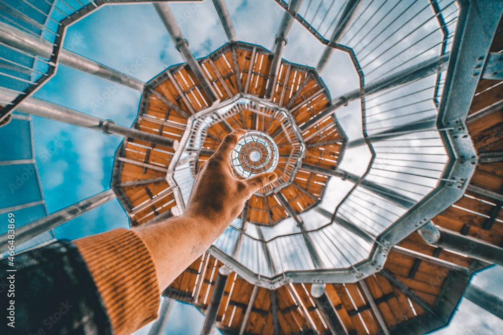 Hand trying to hold spiral staircase from down below Stock Photo ...