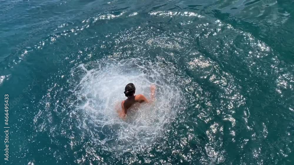 Young girl jumping into the blue sea from boat on vacation Stock Video ...