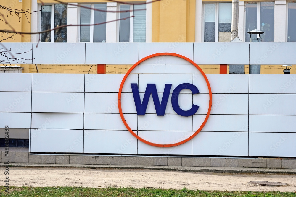 Large letters WC on facade of building. WC sign on the wall. Public ...