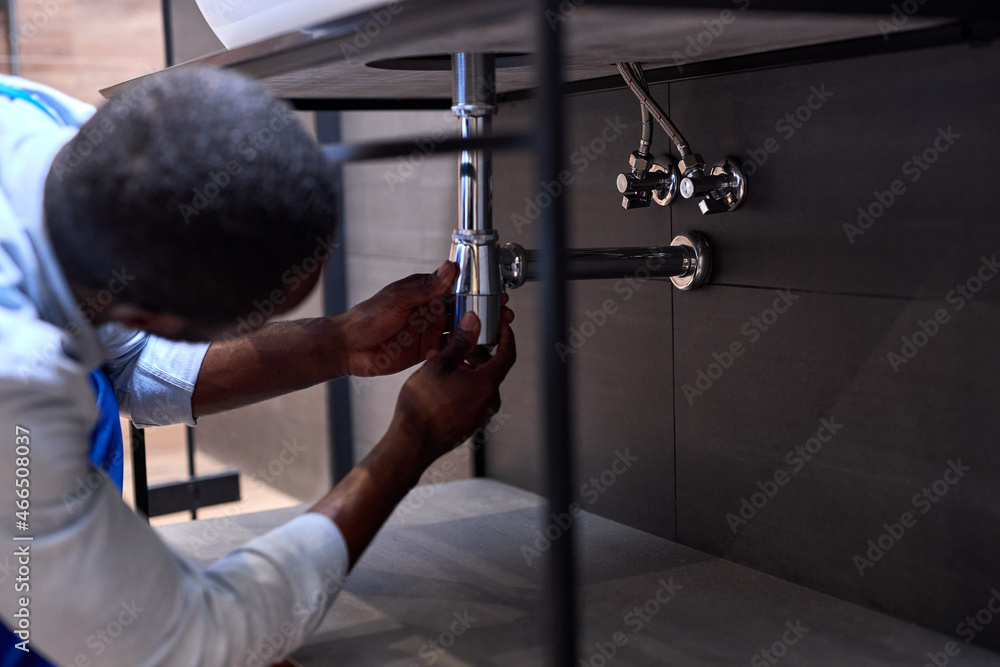 Handsome Hardworking Plumber Installing The Sink In Bathroom Close-up ...