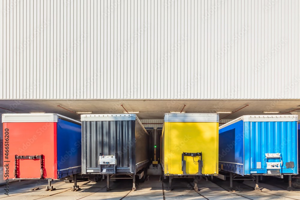 Colorful truck trailers in front of the loading dock of a Dutch ...