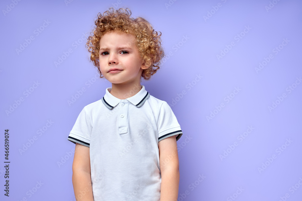 Portrait of unhappy dark skinned child with sullen look, curves lips ...