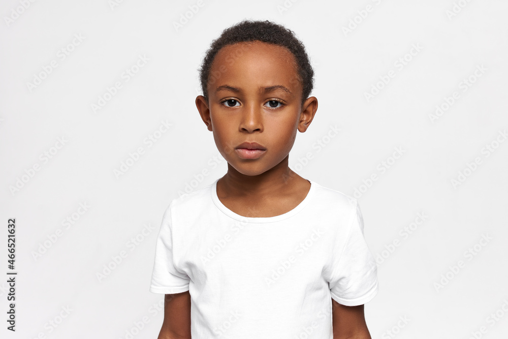 Serious African American kid, having focused and concentrated face ...