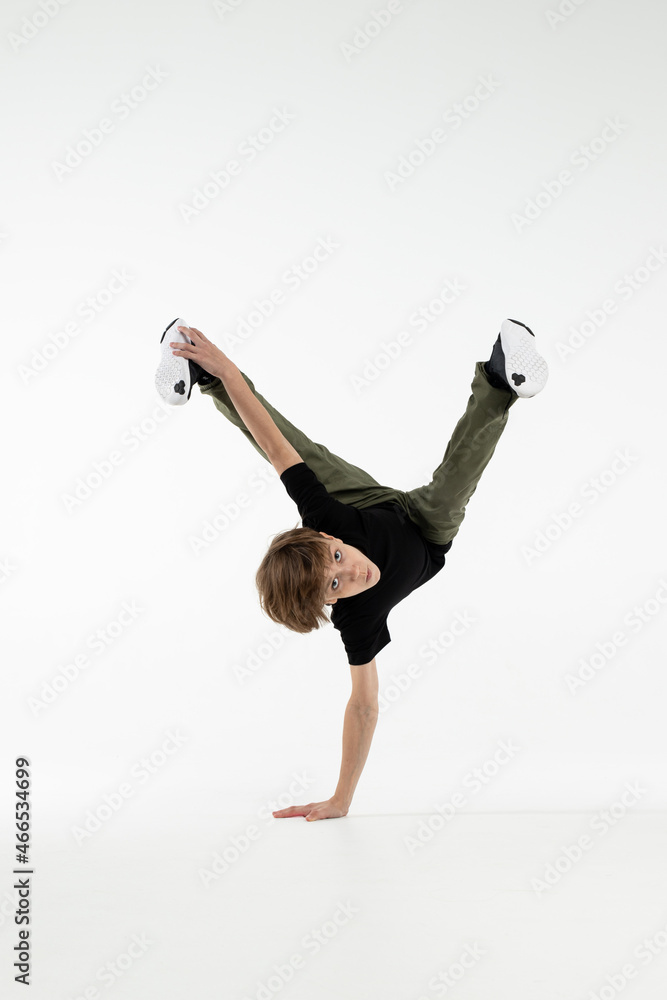 Isolated young Russian teenage boy in black t-shirt hip hop break ...