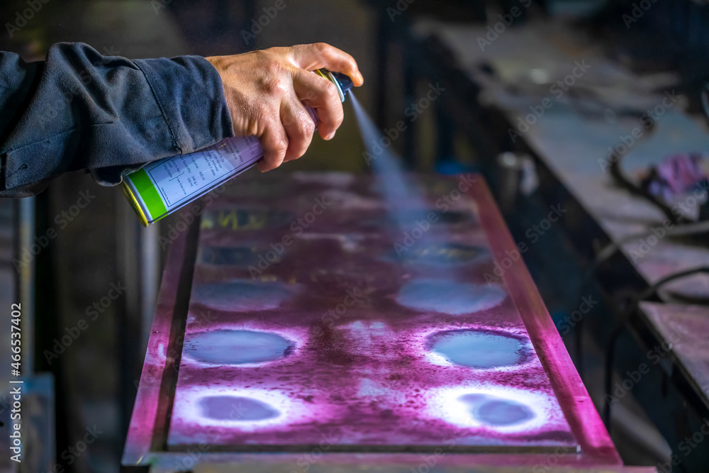 Spraying liquid penetrant to detect defects in welds. Detection of ...
