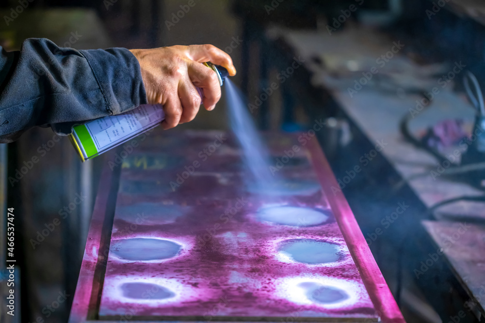 Stockfoto Spraying liquid penetrant to detect defects in welds ...