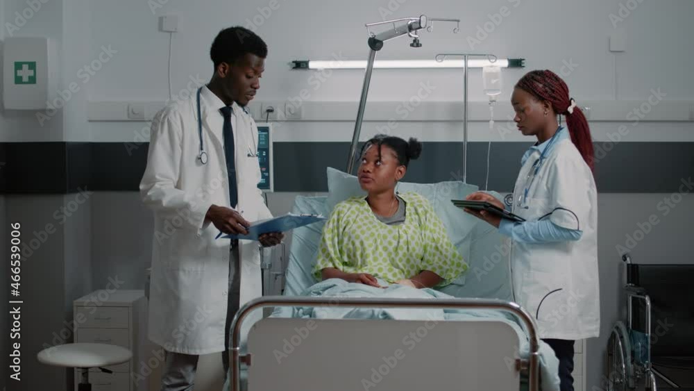 Team of doctors giving assistance to sick woman in bed. Medical ...