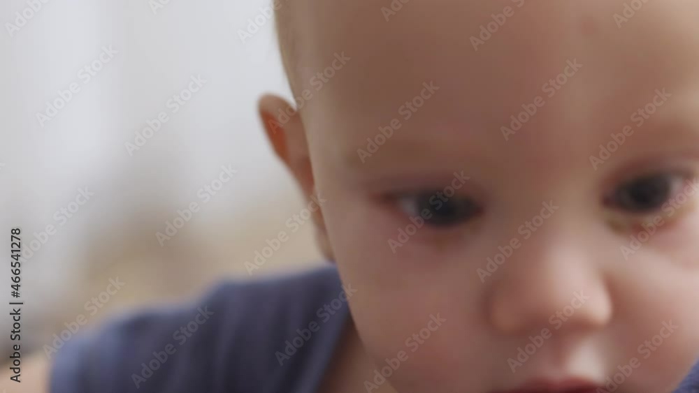 close-up view of blue eyed caucasian baby face with pink eye ...