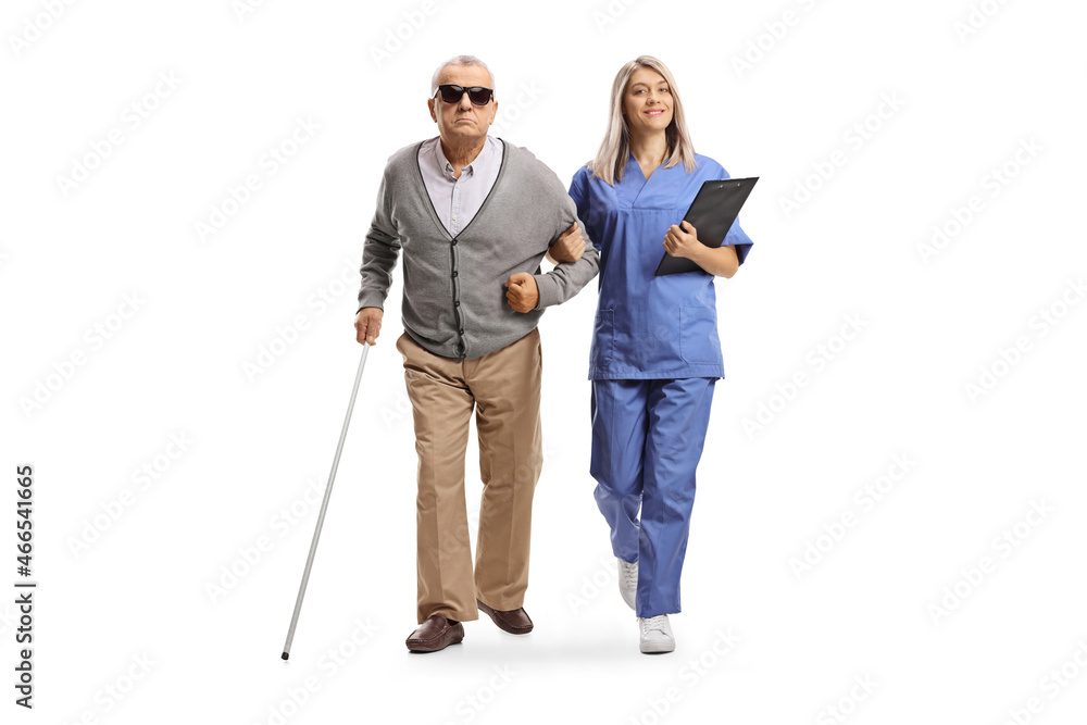 Full length portrait of a young female nurse in a blue uniform walking ...