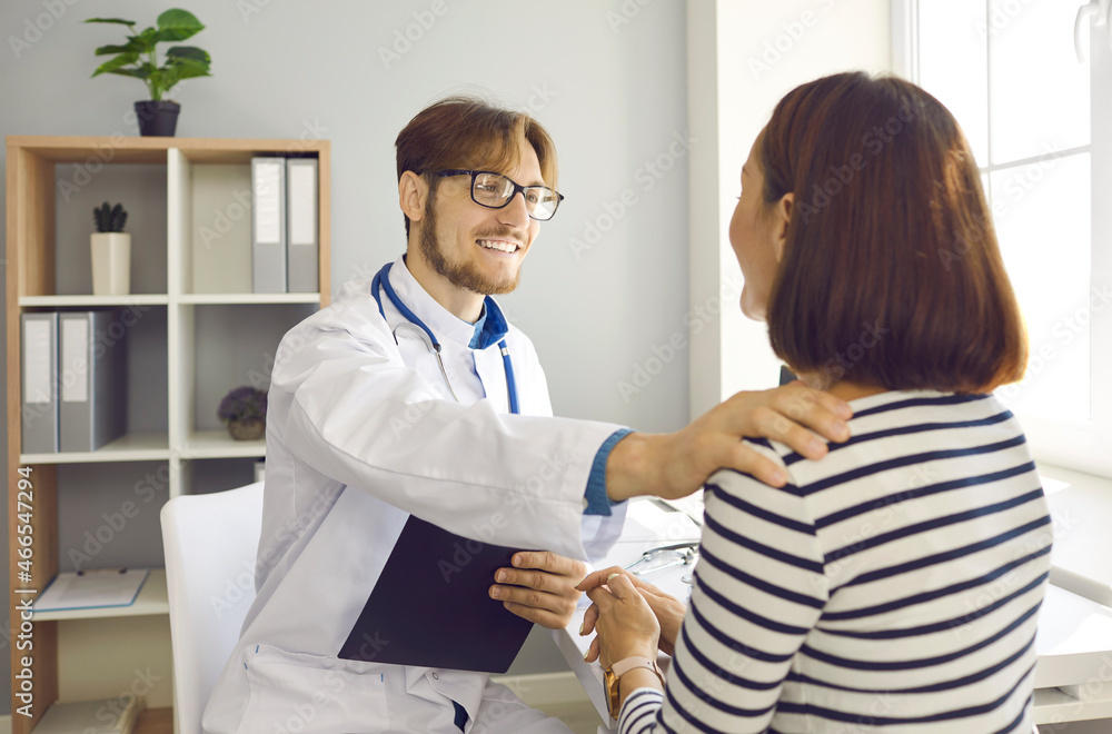 Smiling doctor having friendly conversation with patient. Male ...