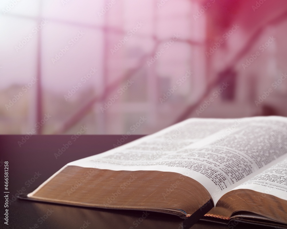 The book is reflected in the table as a symbol of bible. Concept ...