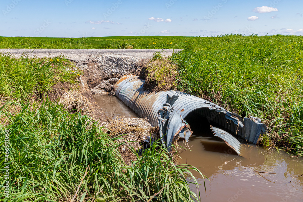 Road and culvert damage due to flooding and water erosion. Road repair ...