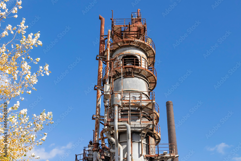 Industrial, rusty and old blast furnace / steel mill with pipelines ...