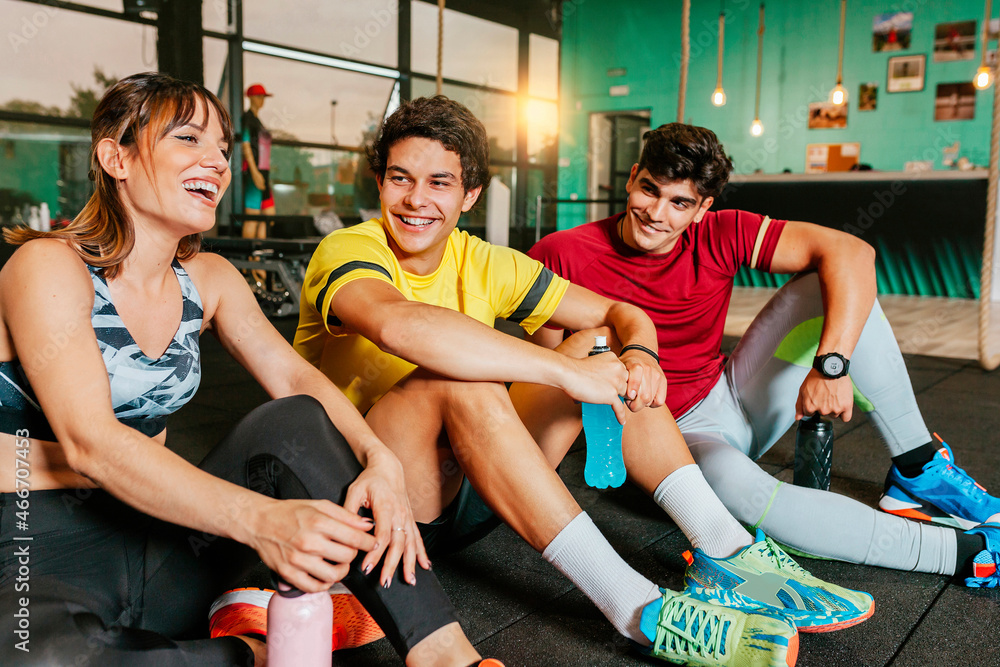Portrait of a group of smiling friends laughing together after a gym ...