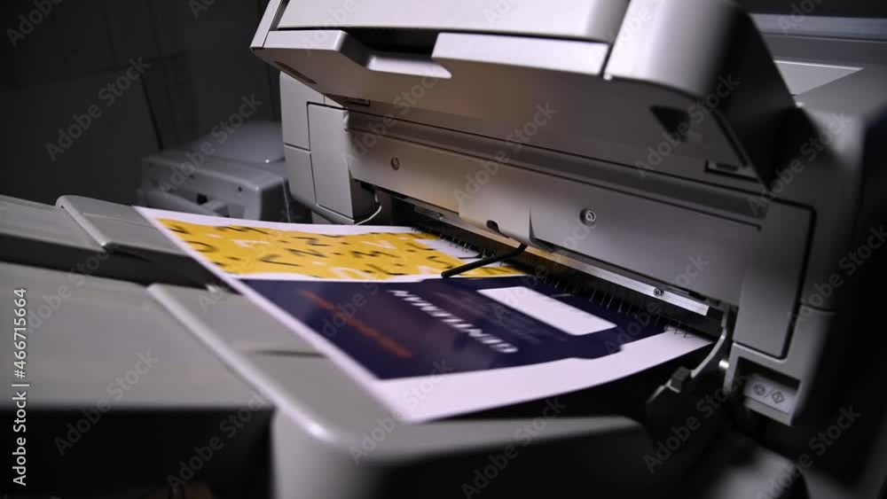 Close-up of an industrial printer output mechanism work. Paper exit ...