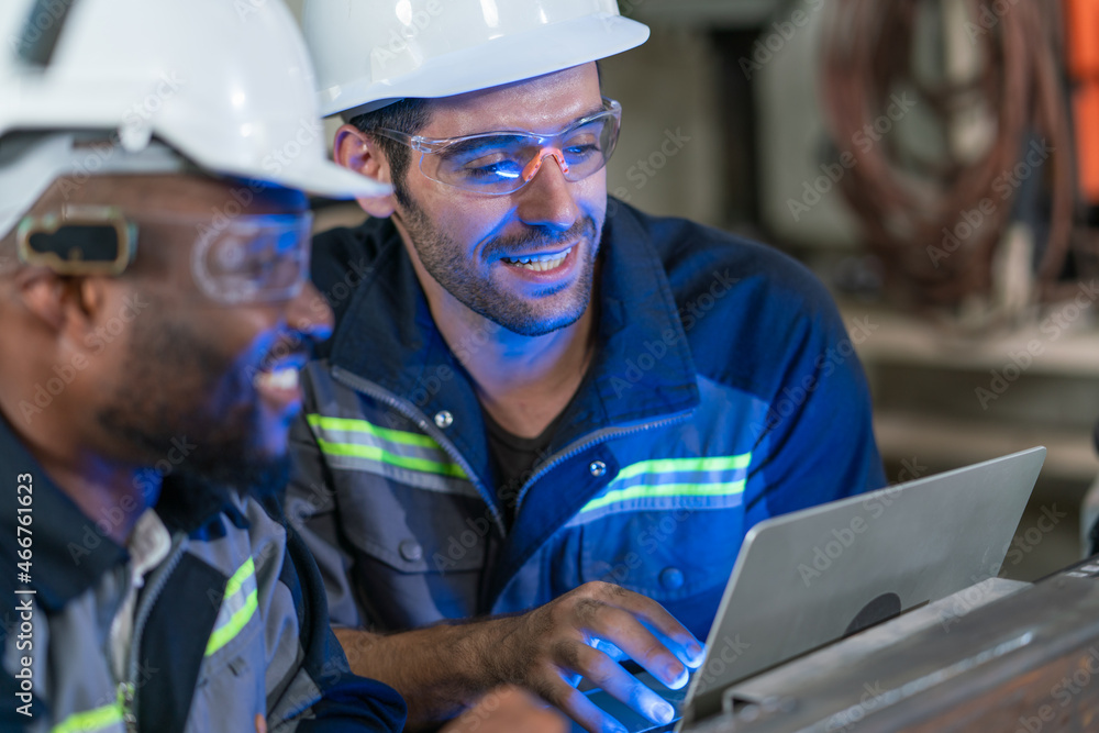 Male automation engineer checking and inspection control a robot arm ...