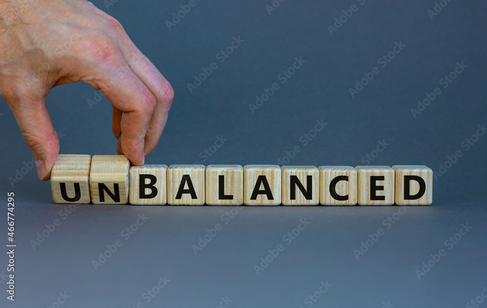 Balanced or unbalanced symbol. Businessman turns cubes, changes words ...