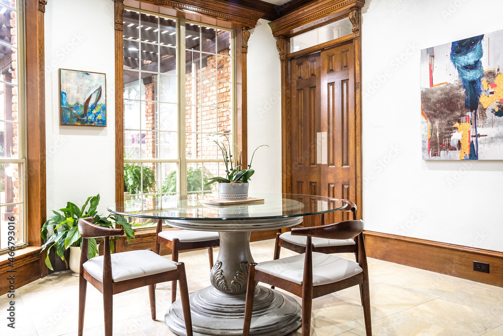 Eclectic casual dining room with glass table, wood trim , high ceilings ...