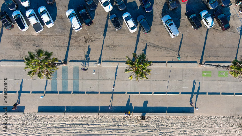an aerial shot of a smooth bike trail at the beach with people walking ...
