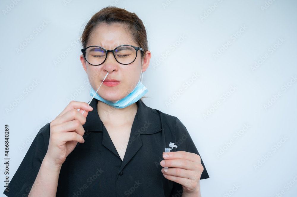 Portrait of Asian woman using rapid antigen test by nasal swab herself ...