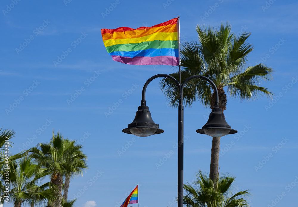 Gay pride flag hanging on a lamppost Stock Photo | Adobe Stock