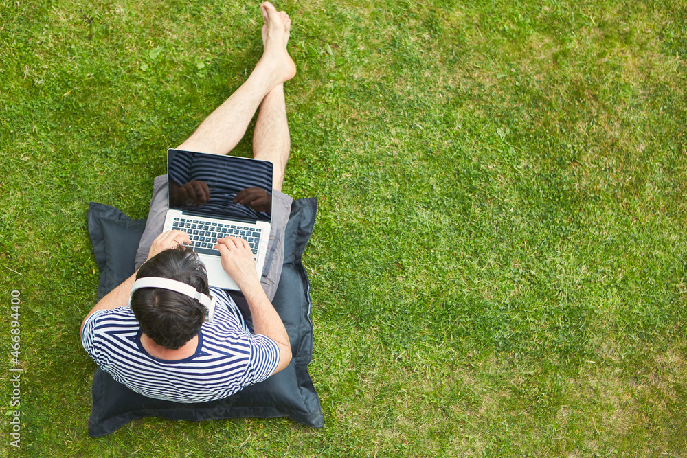 Man using laptop computer on the lawn in the garden Stock Photo | Adobe ...