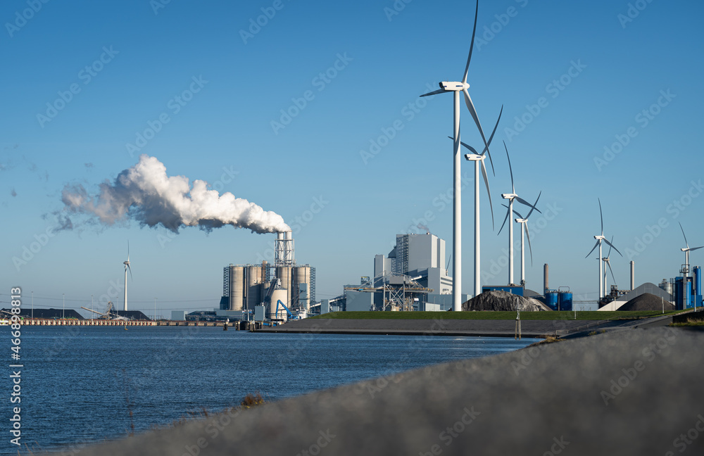 Fossil fuel (coal) power station and wind turbines in the Eemshaven ...