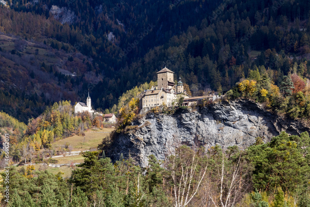Ortenstein Castle (built in 1250) and the Cathlic church Tomlis near ...