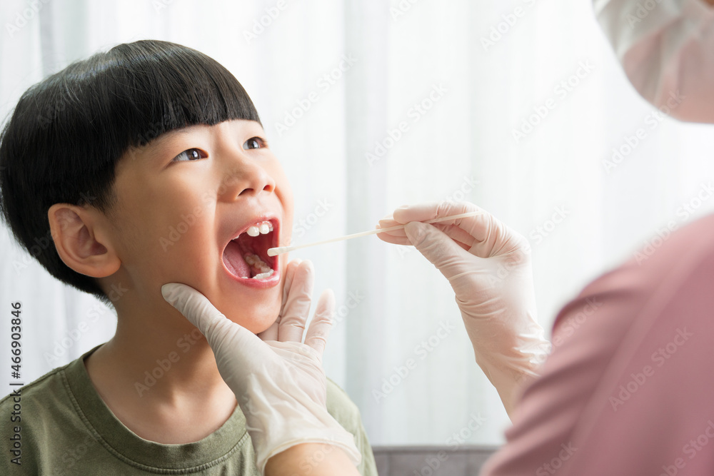 Covid 19 regular testing for student. A teacher gently do a throat ...