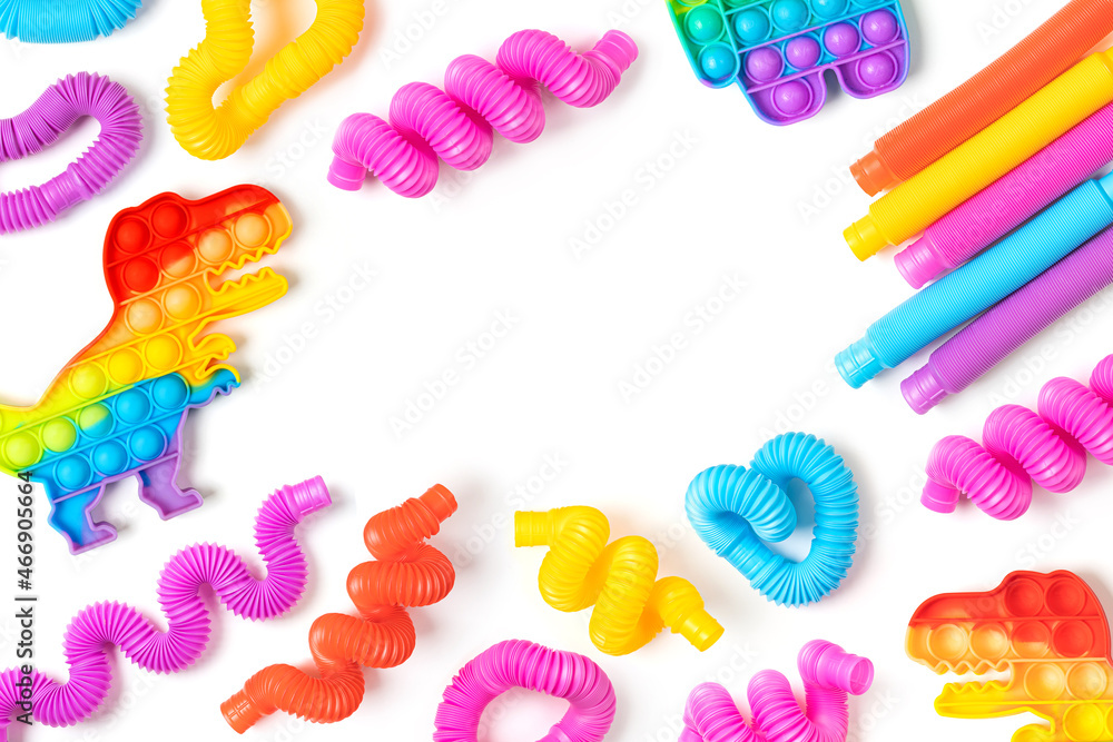 Trendy kids toys — colorful pop-tubes and pop-it on white background ...