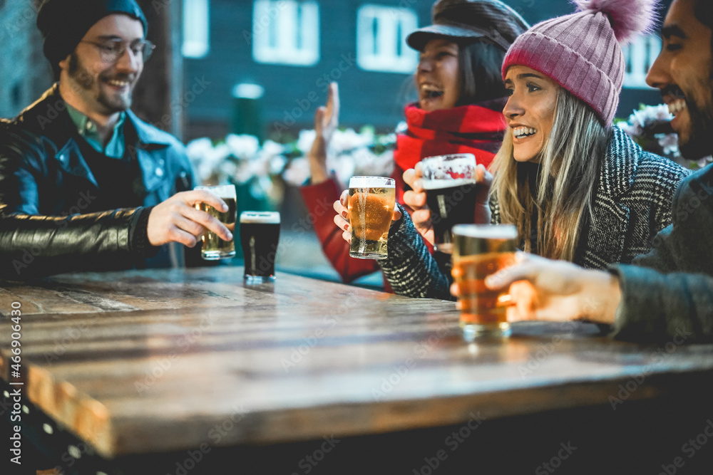 Young people having fun drinking beer at bar restaurant - Soft focus on ...