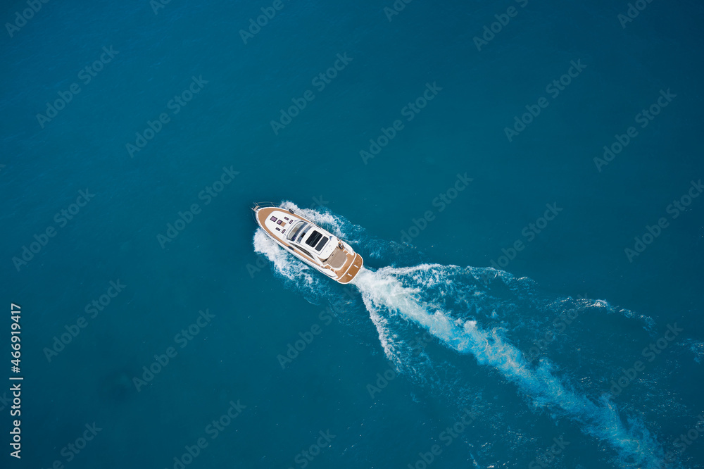 Top view of a white high-speed boat. Yacht movement on blue water top ...