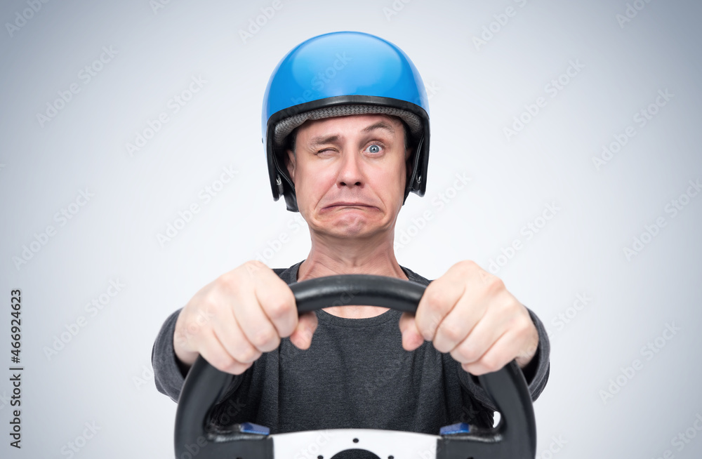 Emotionally scared man in blue motorcycle helmet looks at the road with ...