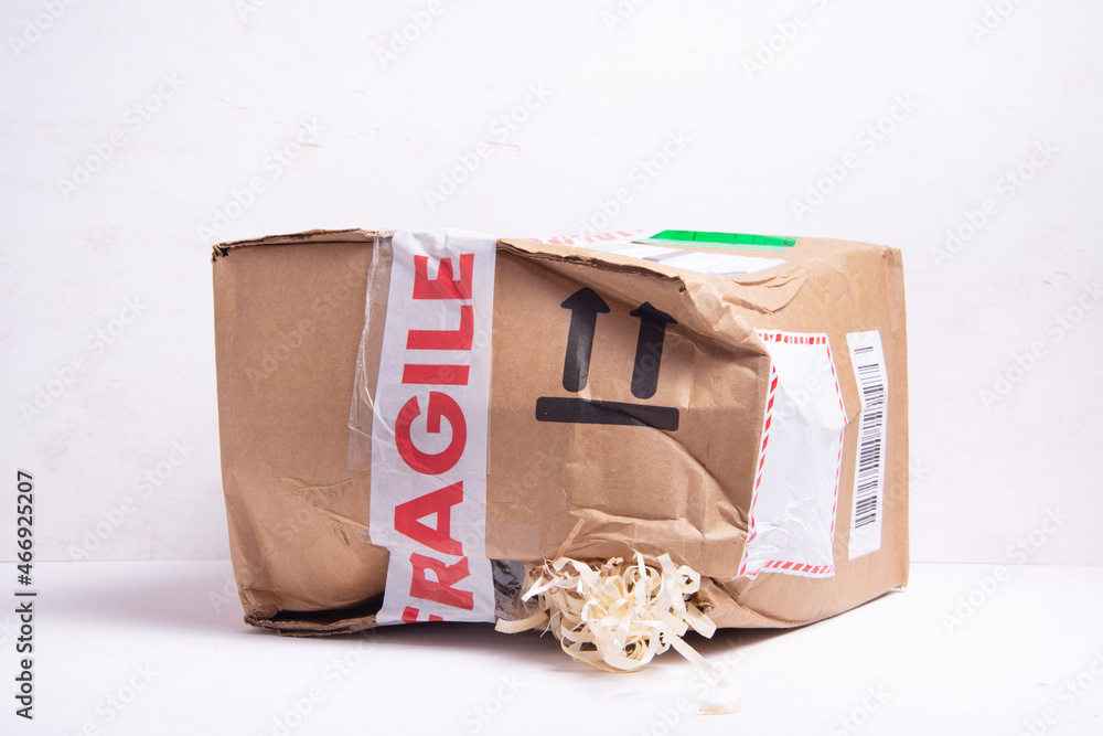 Broken cardboard box, fragille marked parcel Stock Photo | Adobe Stock