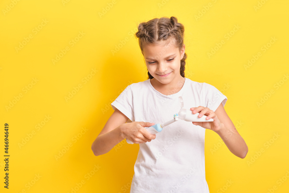 cute teenage girl with pigtails hairstyle squeezes toothpaste on an ...