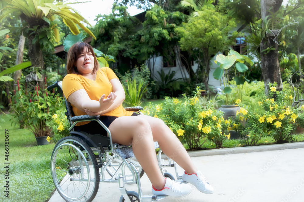 Fat woman sat on a wheelchair because she was suffering from paralysis ...