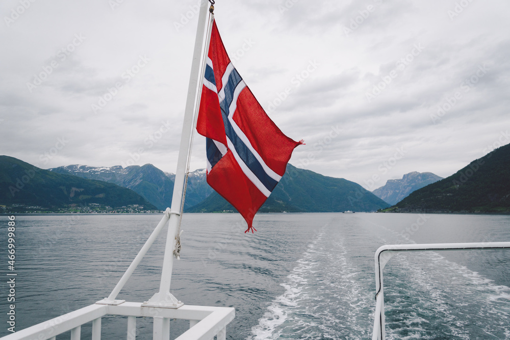 Norwegian flag hanging on the railing of the ship and waving above the ...