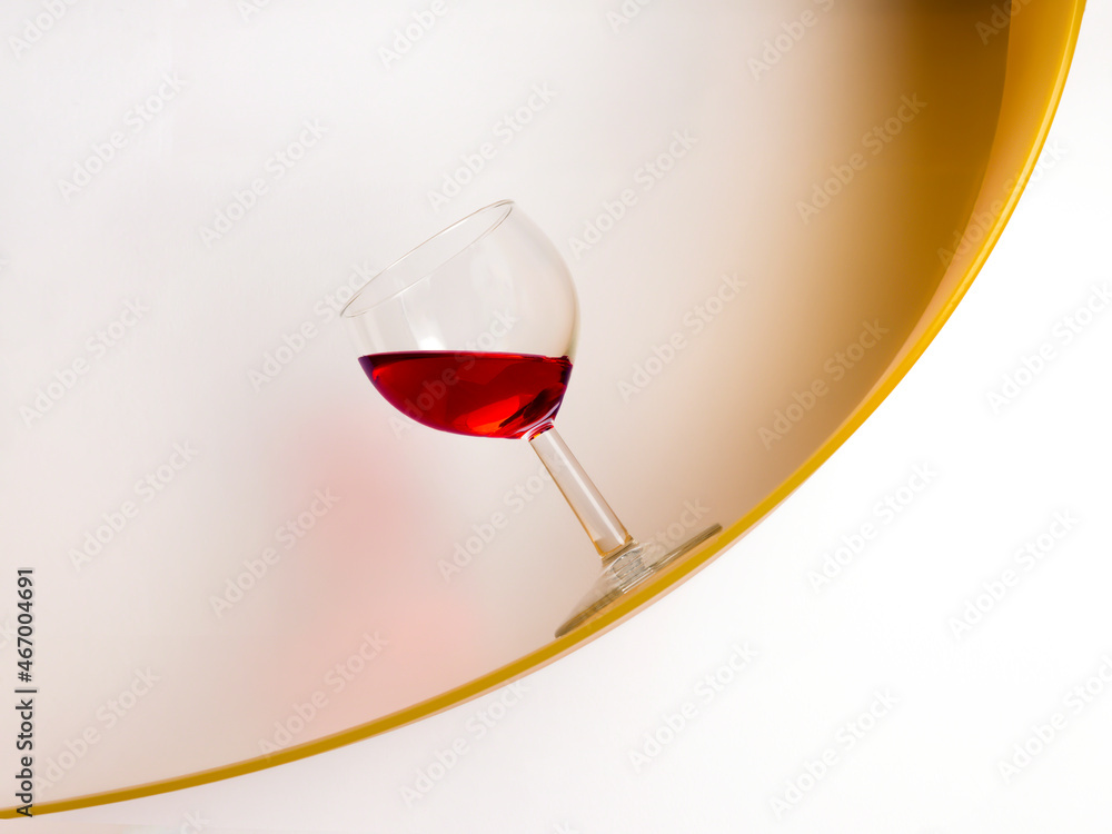 Glass of red wine standing at an angle on a curved shelf Stock Photo ...