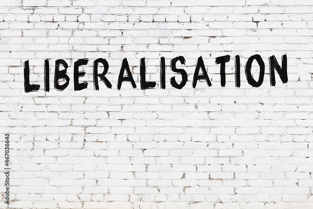 Inscription liberalisation painted on white brick wall Stock ...