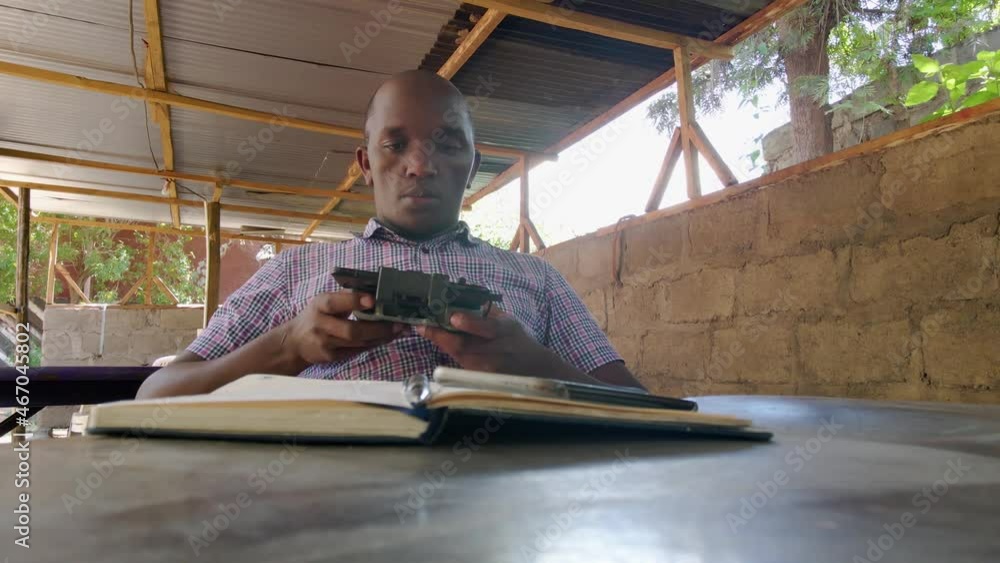 Depressed African student controlling drone during corona. Young ...