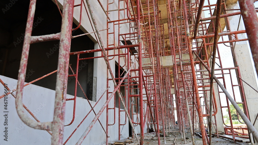 Metal scaffolding at a construction site. The structure of the red ...