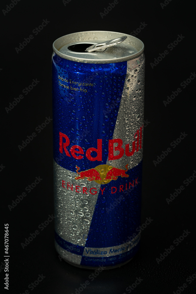 Aluminium can of Red Bull Energy drink with ice and drops. Red Bull is ...