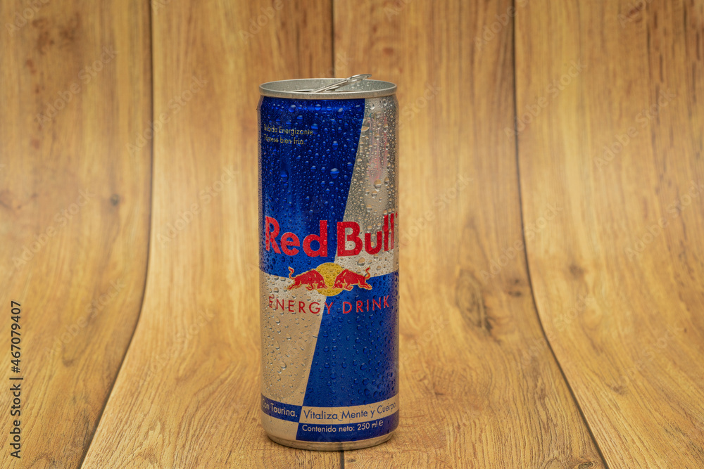 Aluminium can of Red Bull Energy drink with ice and drops. Red Bull is ...