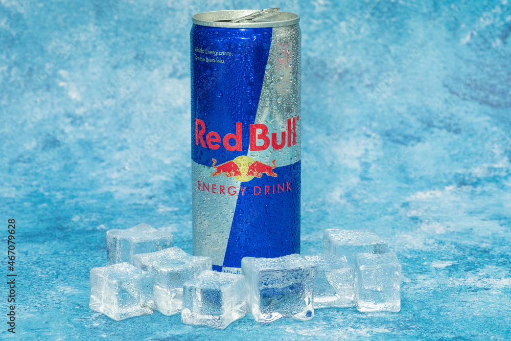 Aluminium can of Red Bull Energy drink with ice and drops. Red Bull is ...
